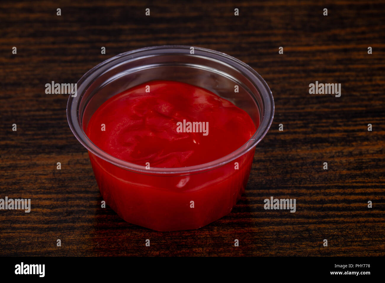 Ketchup sauce portion over wooden Stock Photo - Alamy