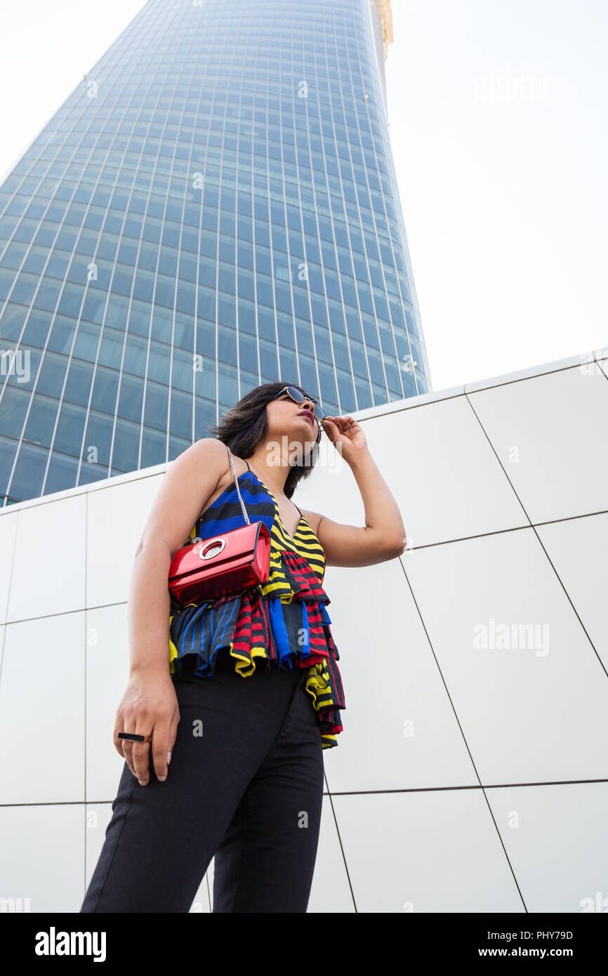 Beautiful young Indian woman posing in an urban context. Street fashion ...