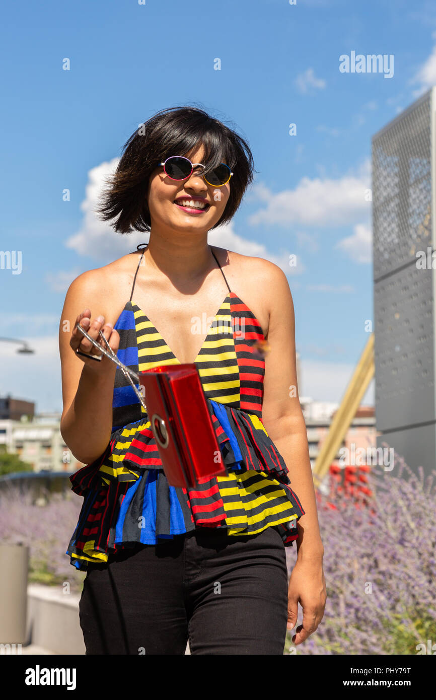Beautiful young Indian woman posing in an urban context. Street fashion and style Stock Photo ...