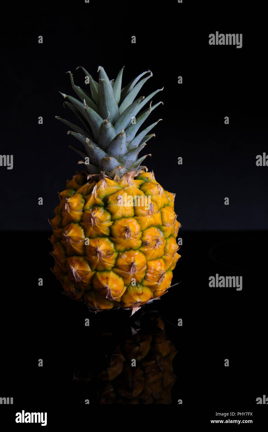 Photograph of a pineapple with dark background Stock Photo - Alamy