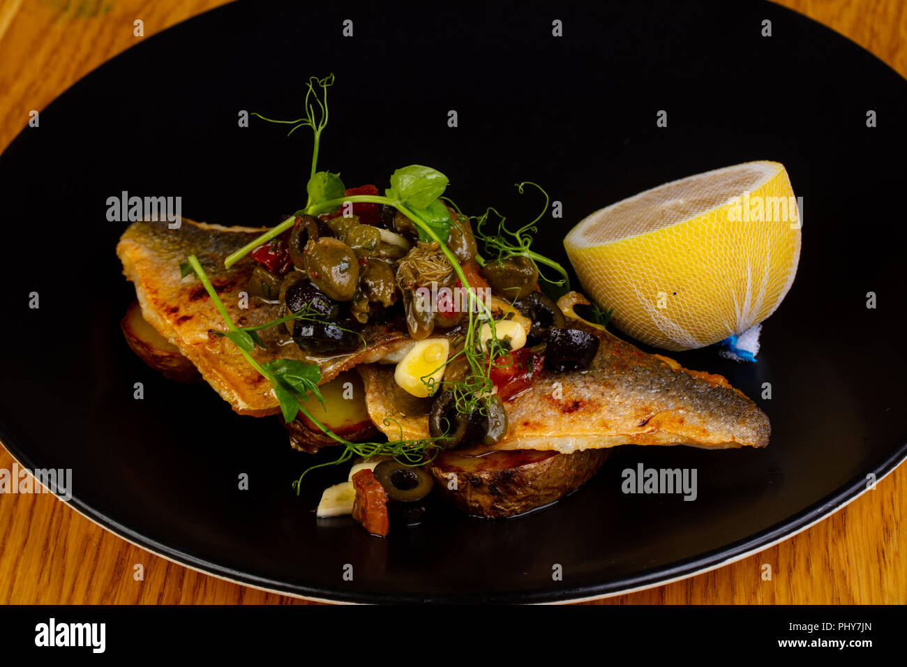 Dorada fillet with herbs and lemon Stock Photo - Alamy