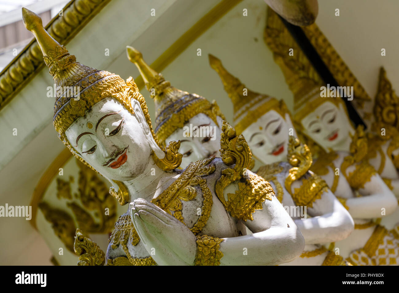 Row of praying mythological figures of the Hindu religion. The statues ...