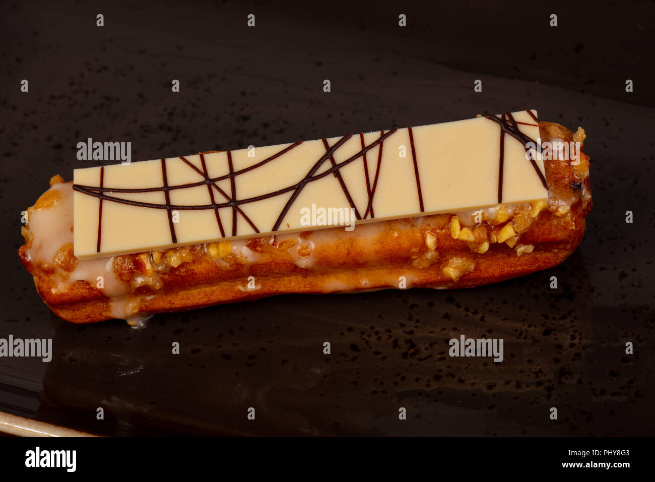 Tasty sweet Eclair with cream Stock Photo - Alamy