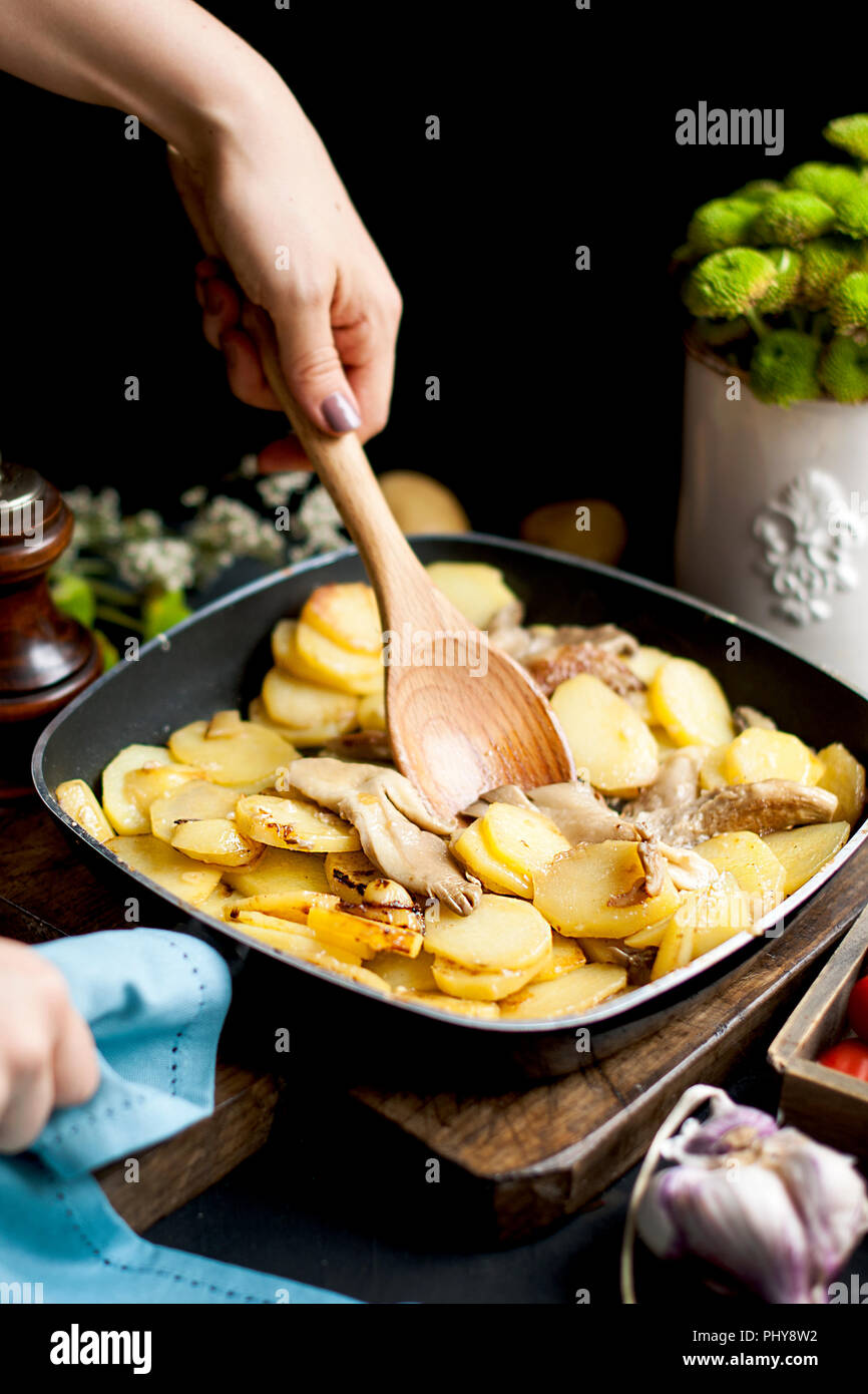 Fried potatoes in a frying pan with creepers and spices. Delicious ...