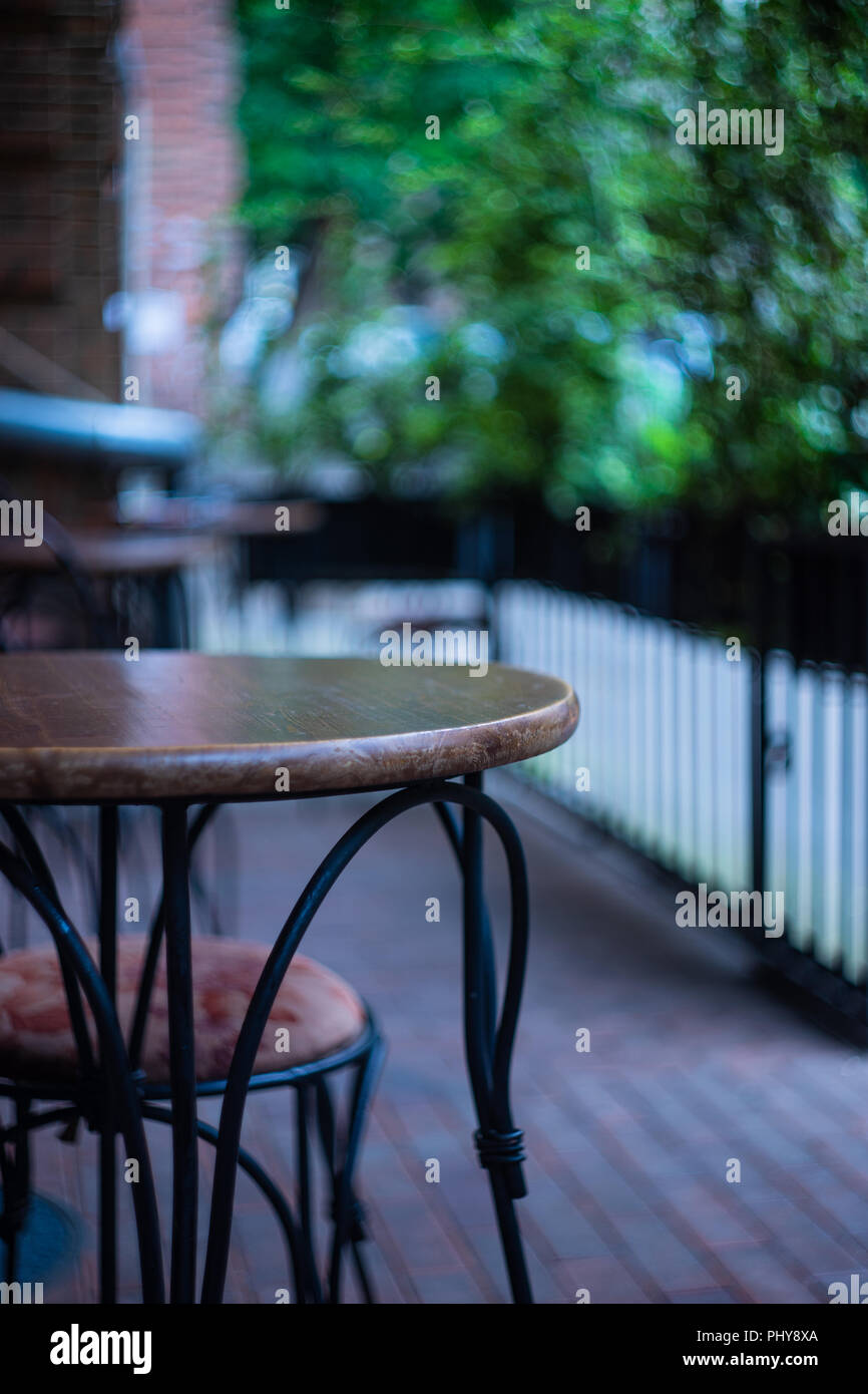 Coffee table with glass of coffee on cafe balcony Stock Photo - Alamy