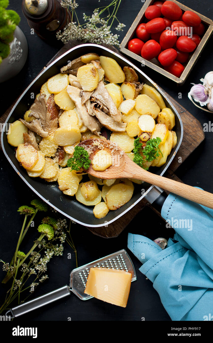 Fried potatoes in a frying pan with creepers and spices. Delicious ...