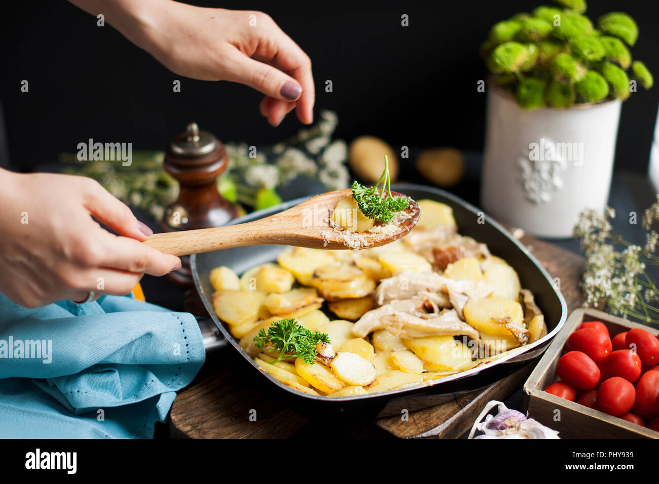 Fried potatoes in a frying pan with creepers and spices. Delicious ...