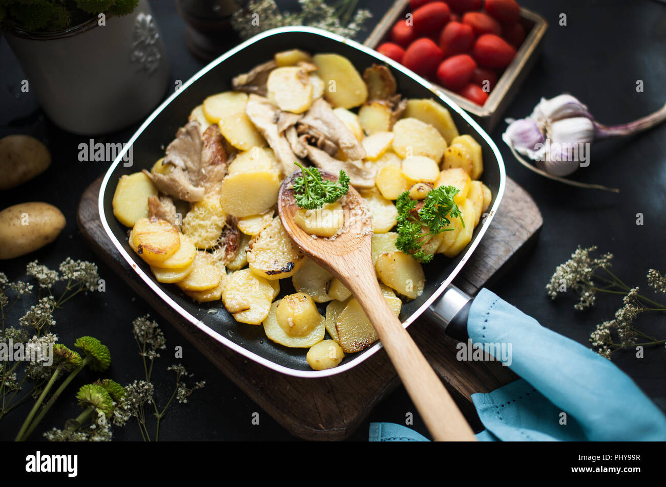 Fried potatoes in a frying pan with creepers and spices. Delicious ...