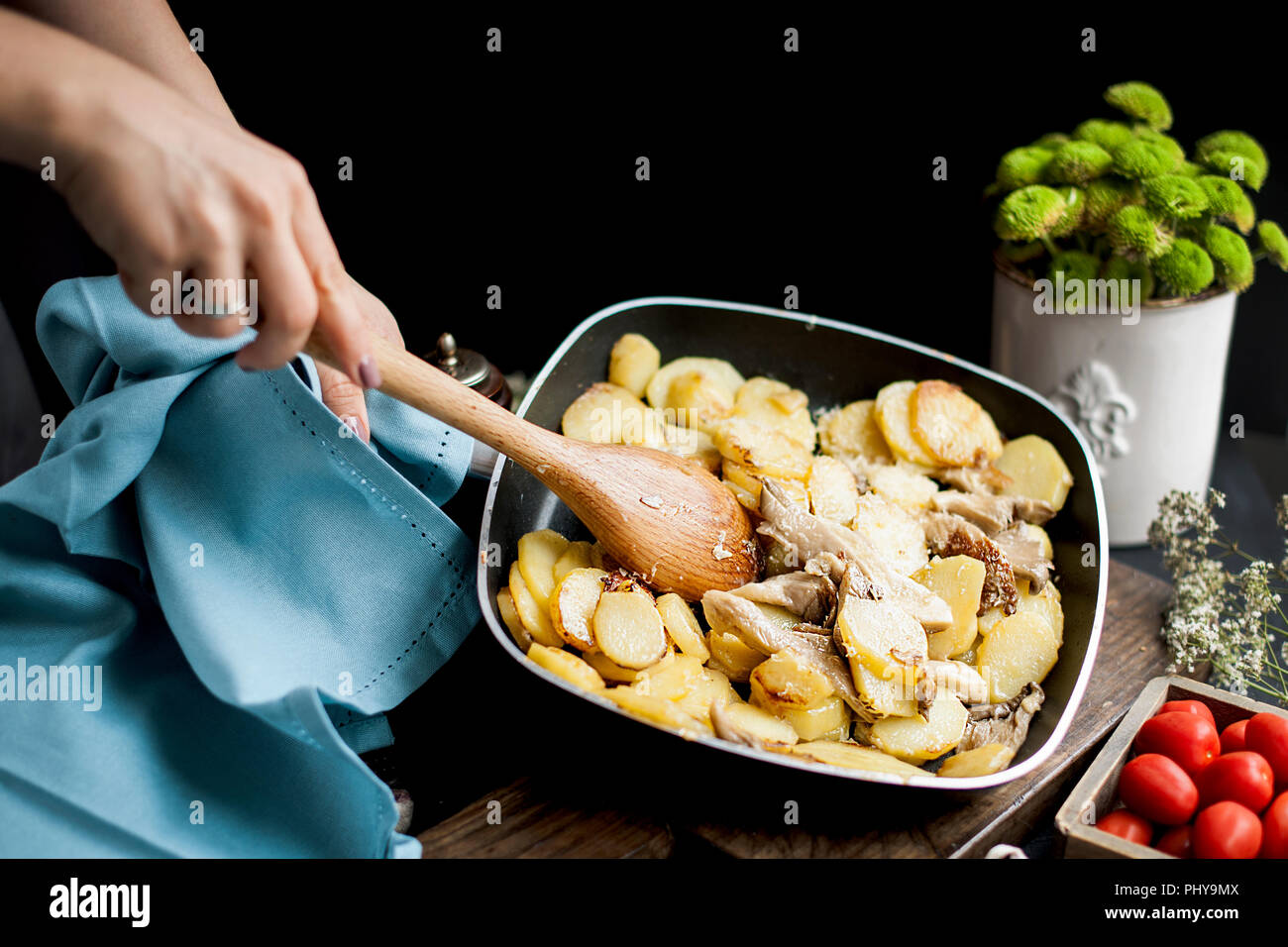 Fried potatoes in a frying pan with creepers and spices. Delicious ...