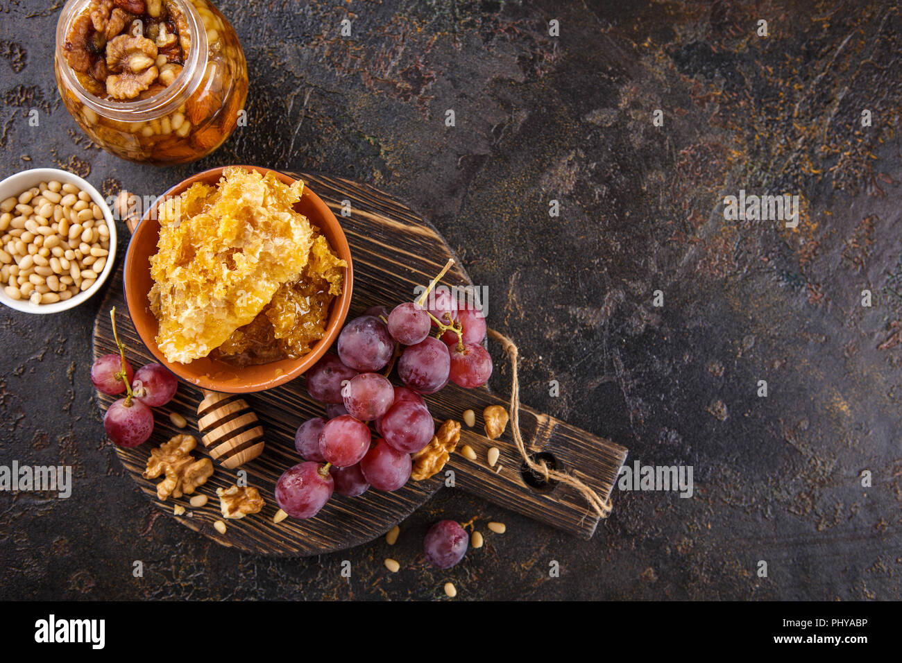 Honey, grapes and nuts Stock Photo - Alamy