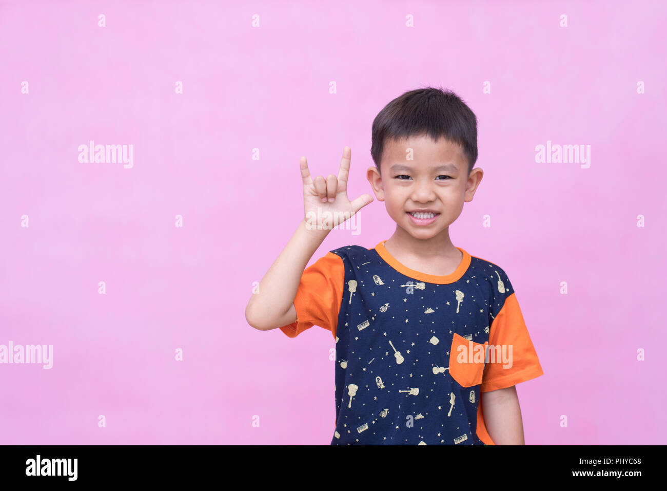 Little boy happy hand sign i love you isolated on pink background Stock ...
