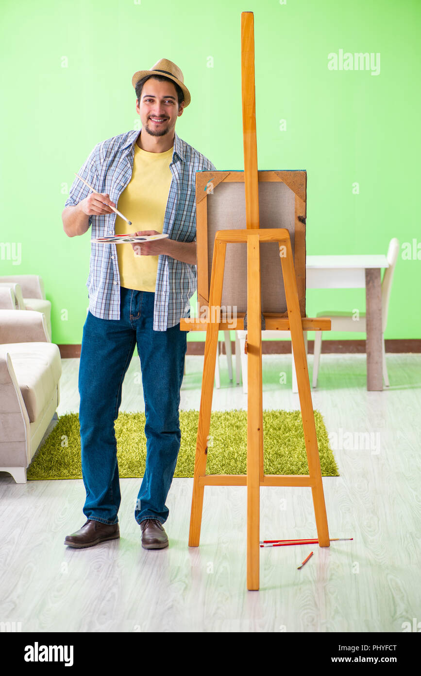 Young male artist working on new painting in his studio Stock Photo - Alamy