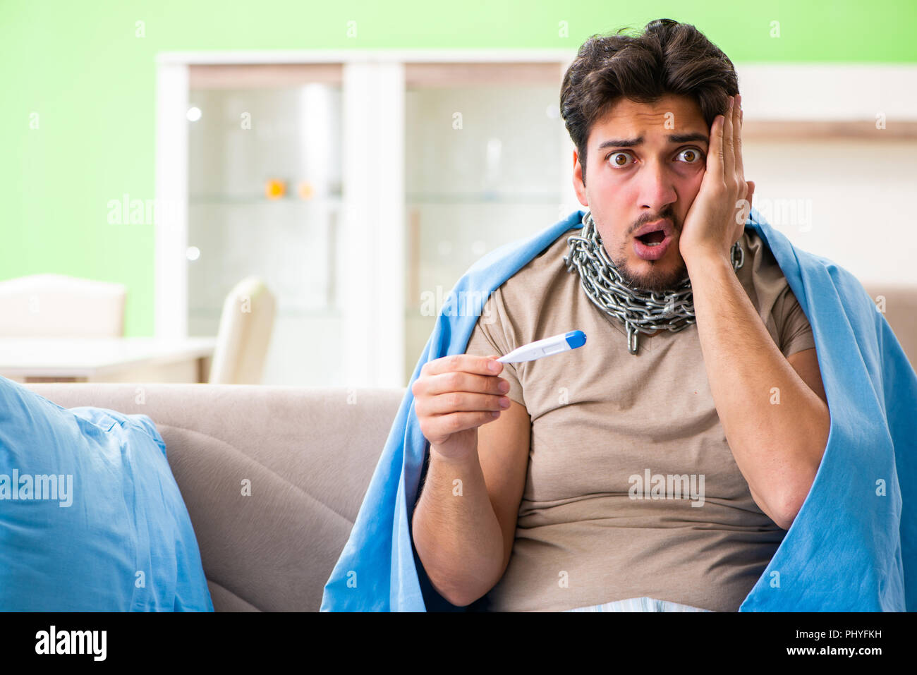 Sick young man suffering from flu at home Stock Photo - Alamy