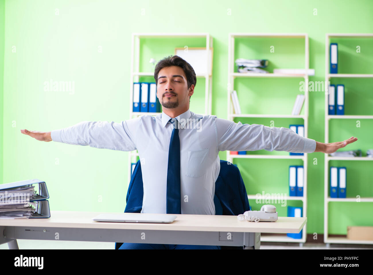 Employee doing exercises during break at work Stock Photo - Alamy