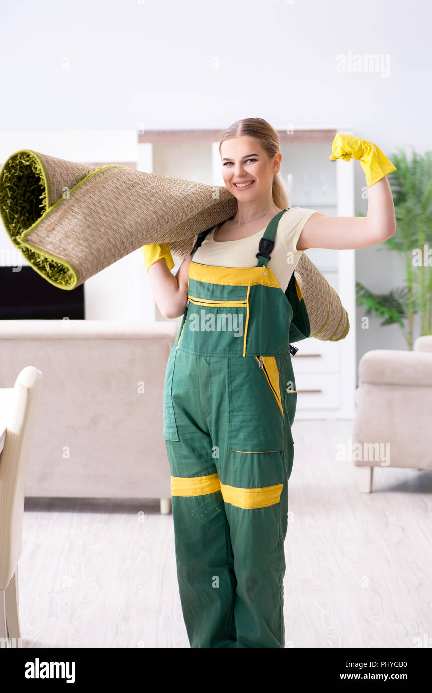 Professional female cleaner cleaning carpet Stock Photo - Alamy