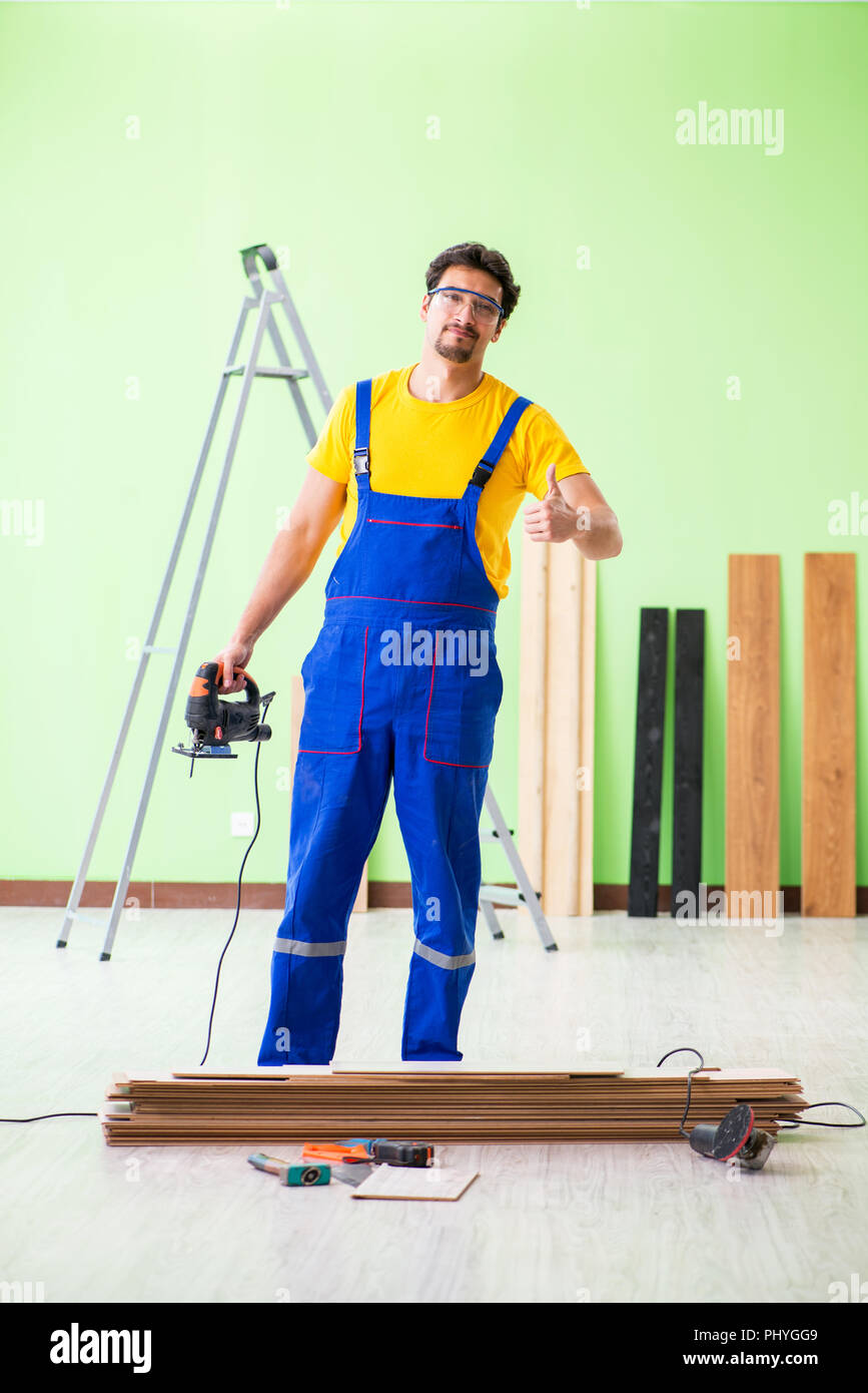 Professional contractor laying flooring at home Stock Photo - Alamy