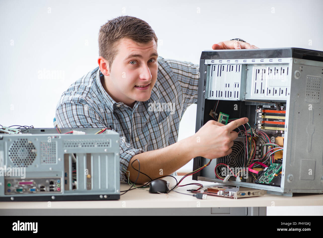 Young technician repairing computer in workshop Stock Photo - Alamy