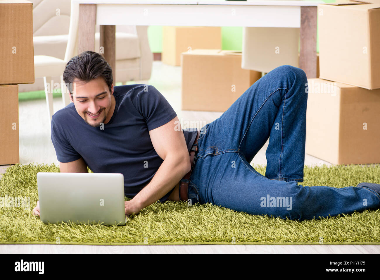 Man moving house with boxes Stock Photo - Alamy