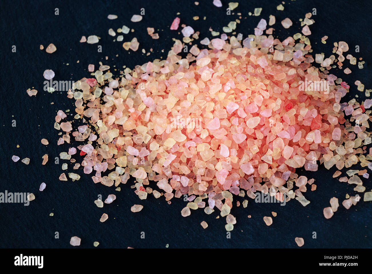 Pile of Pink Himalayan salt in jar on dark slate background. Top view ...