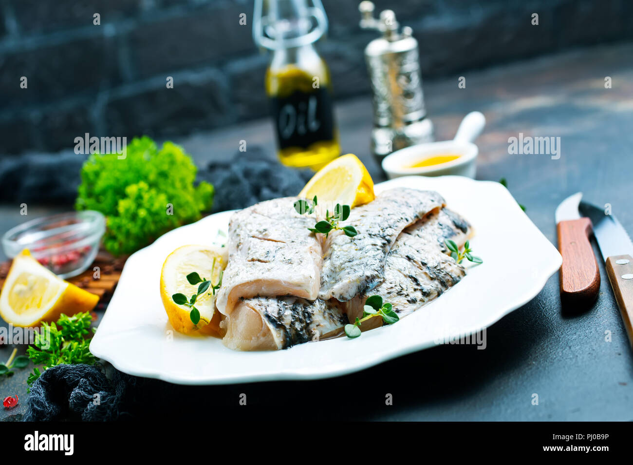 raw fish fillet with spice and lemon Stock Photo - Alamy
