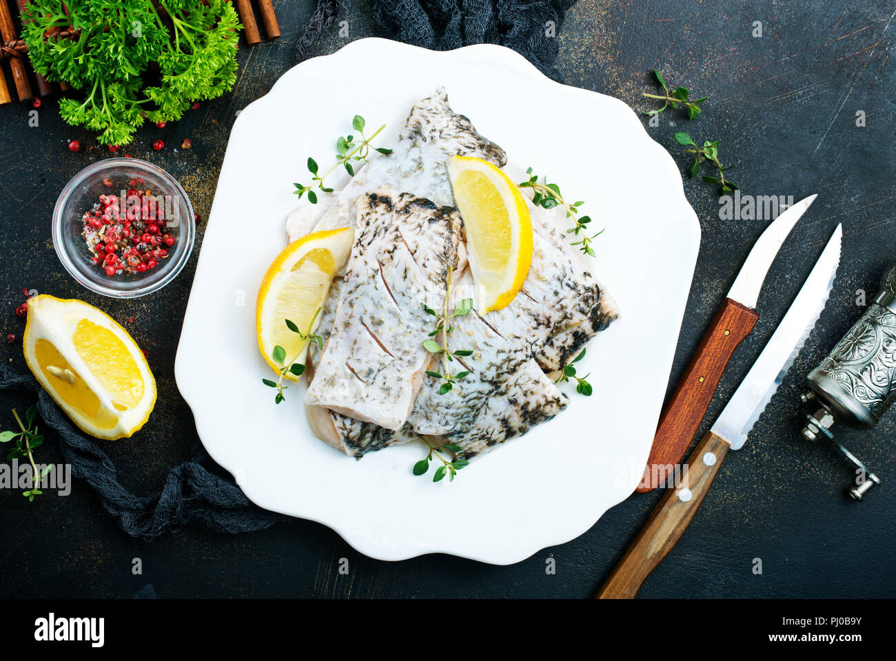 raw fish fillet with spice and lemon Stock Photo - Alamy