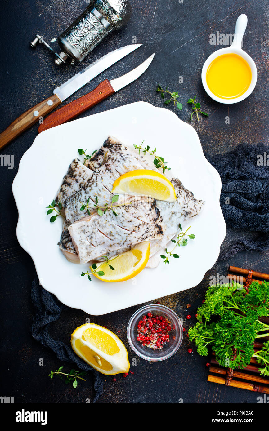 raw fish fillet with spice and lemon Stock Photo - Alamy