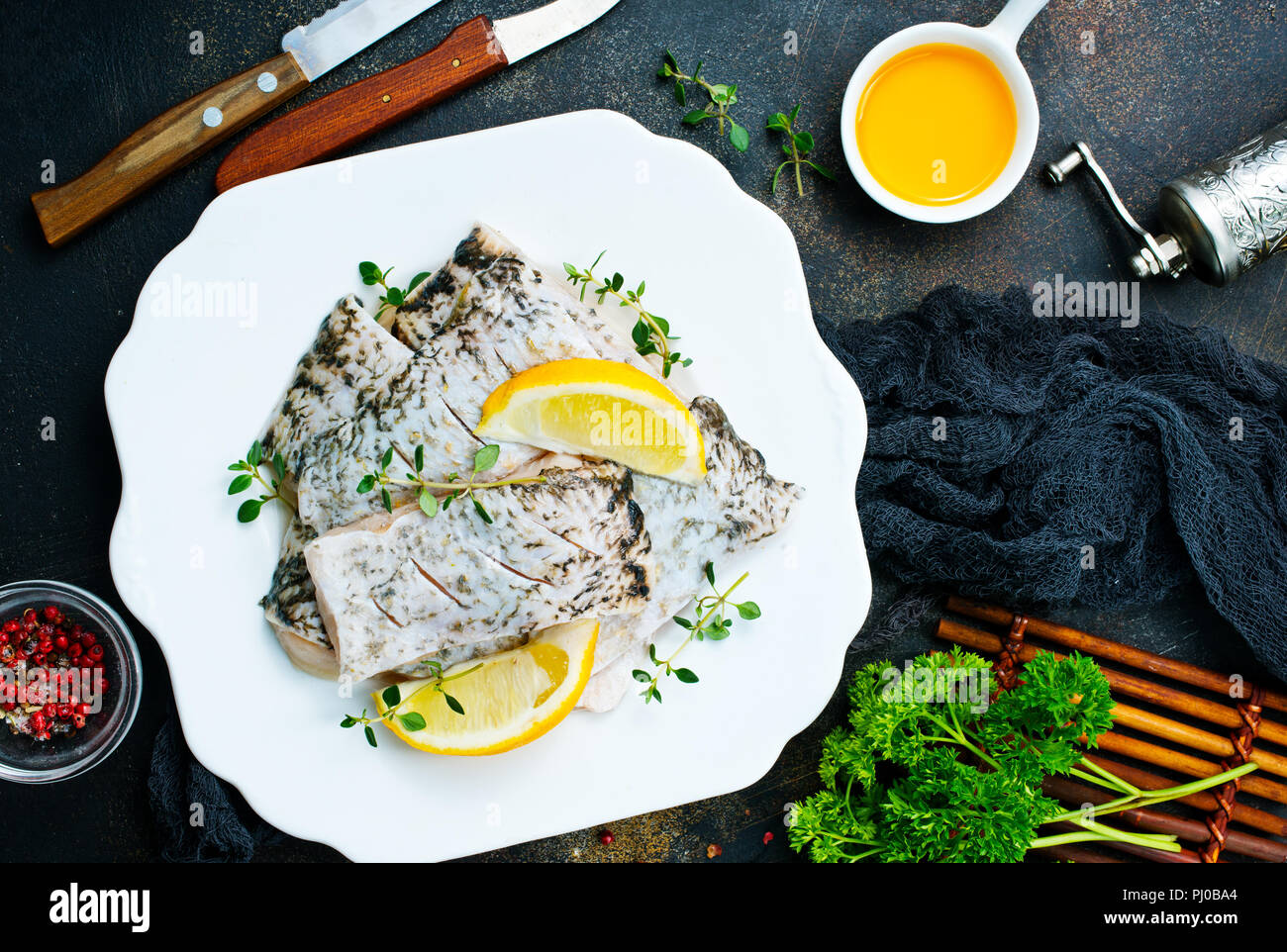 raw fish fillet with spice and lemon Stock Photo - Alamy