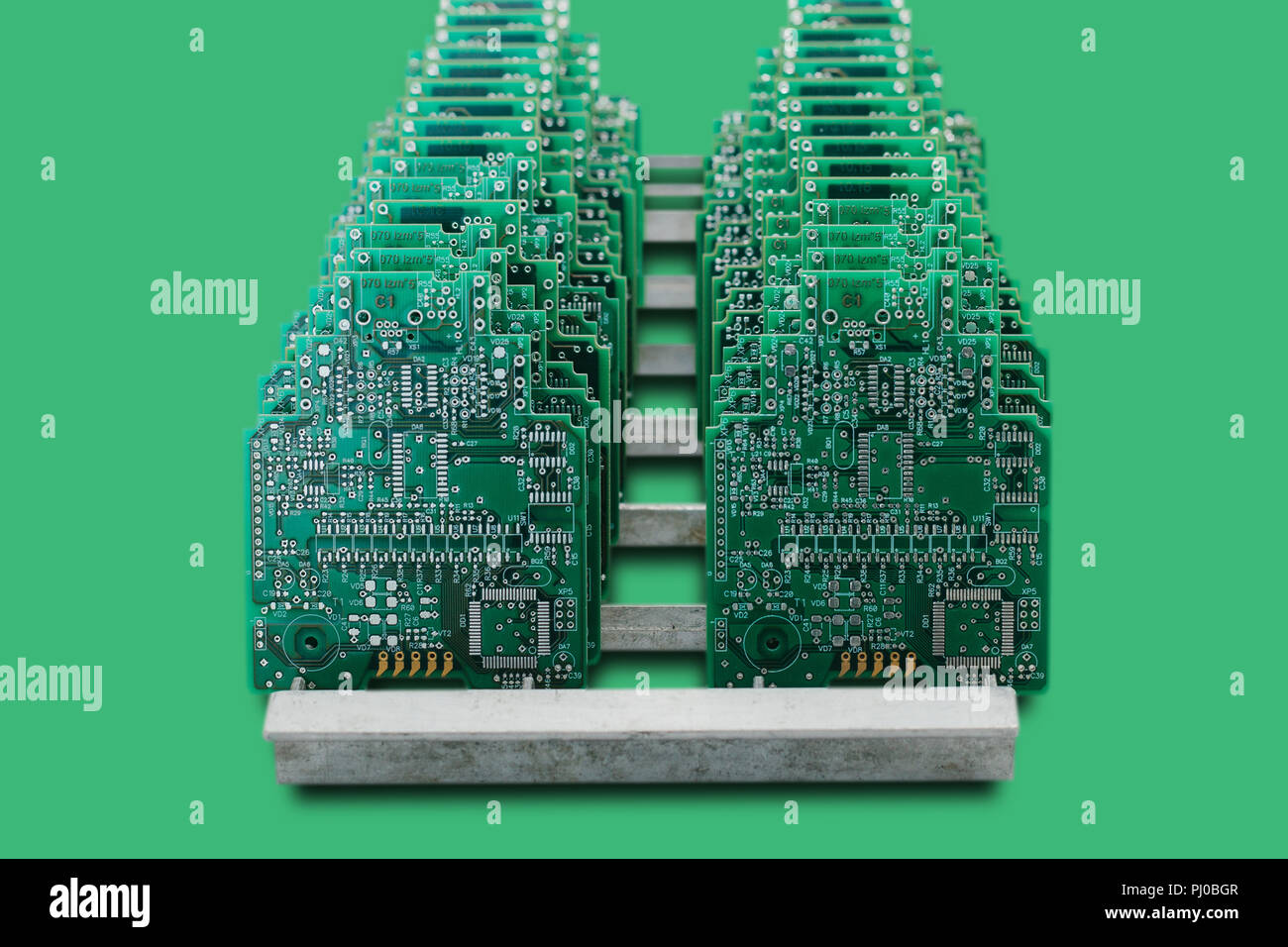 Computer boards in a row on a green background Stock Photo - Alamy