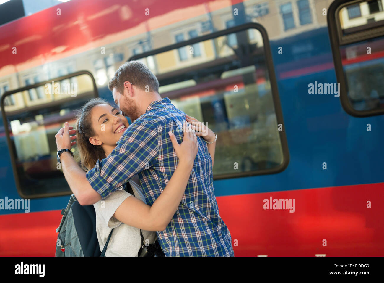 Beautiful couple parting at train station Stock Photo - Alamy