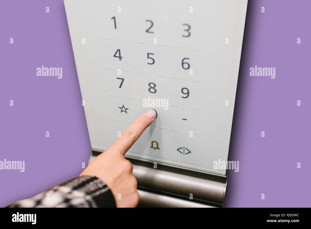 Close-up of a girl pressing a touch button in a modern elevator Stock ...