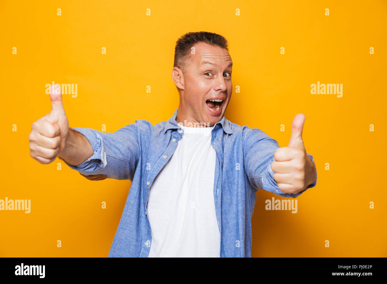 Middle aged businessman showing thumbs hi-res stock photography and ...