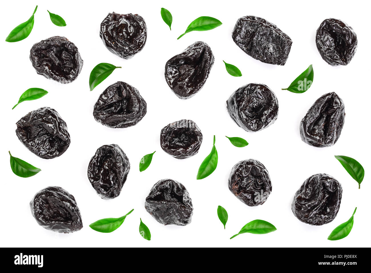 Dried plum - prunes decorated with green leaves isolated on a white ...