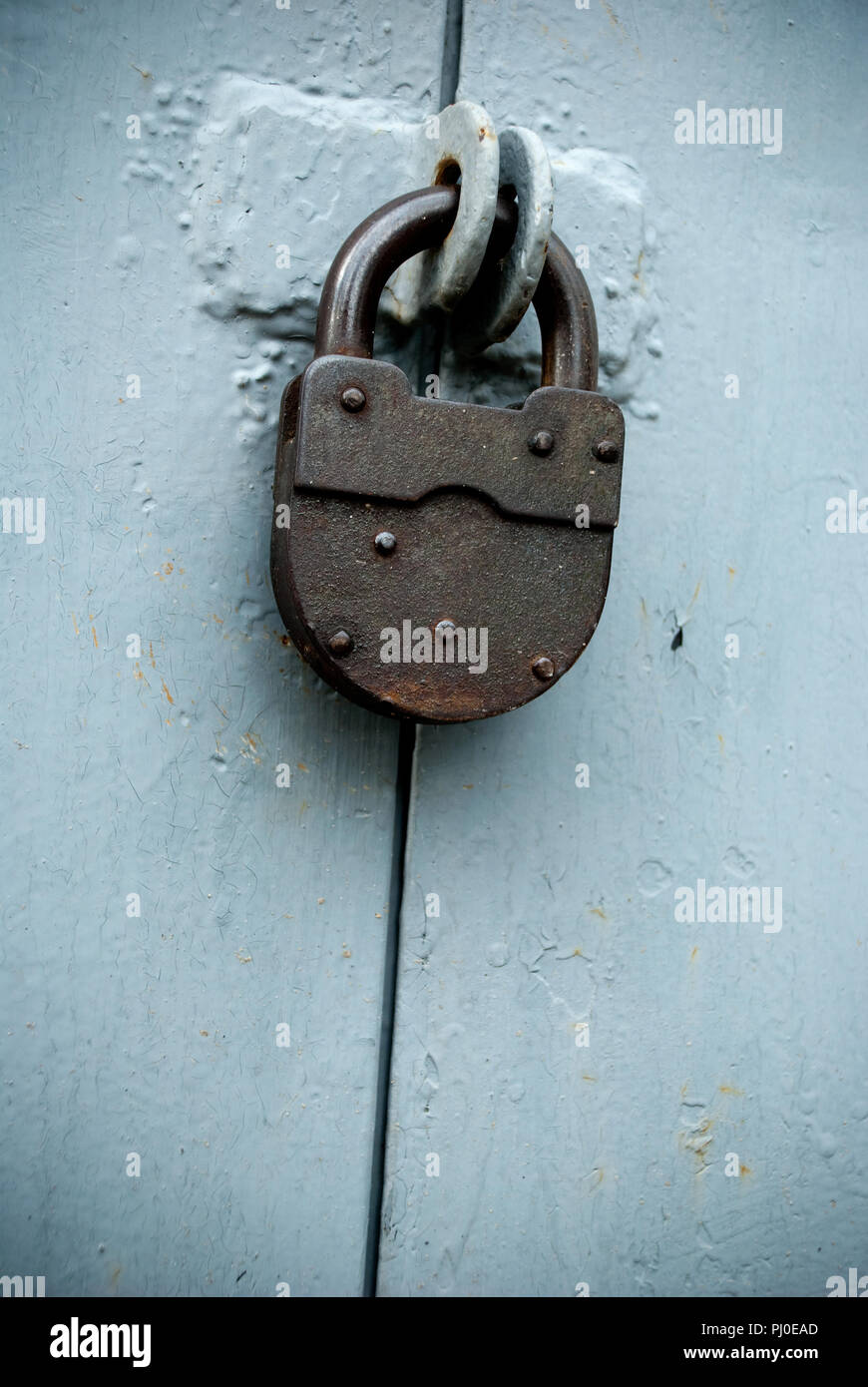 old rusted lock on a blue gate Stock Photo - Alamy
