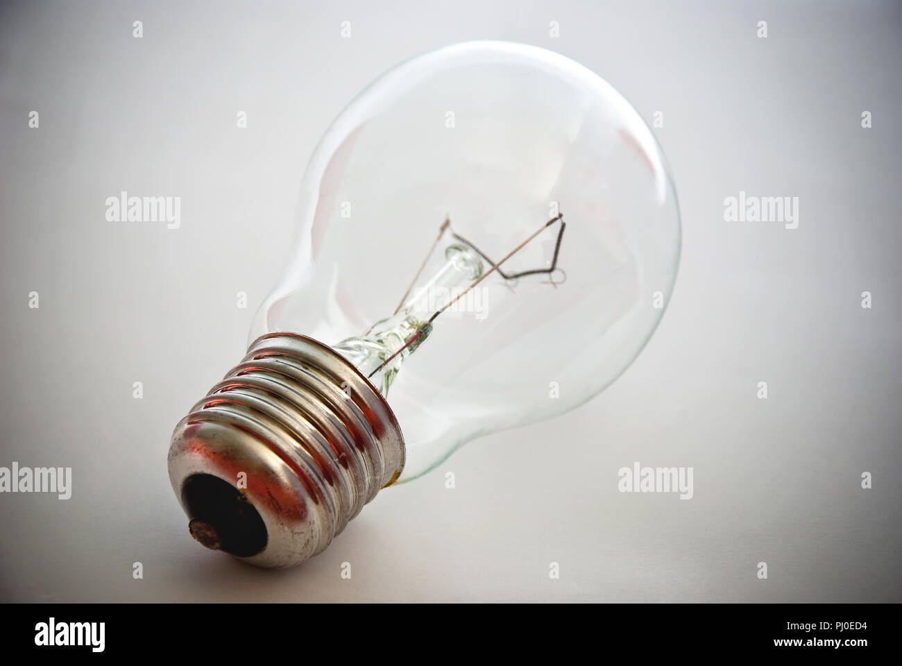 single bulb on a grey background Stock Photo - Alamy