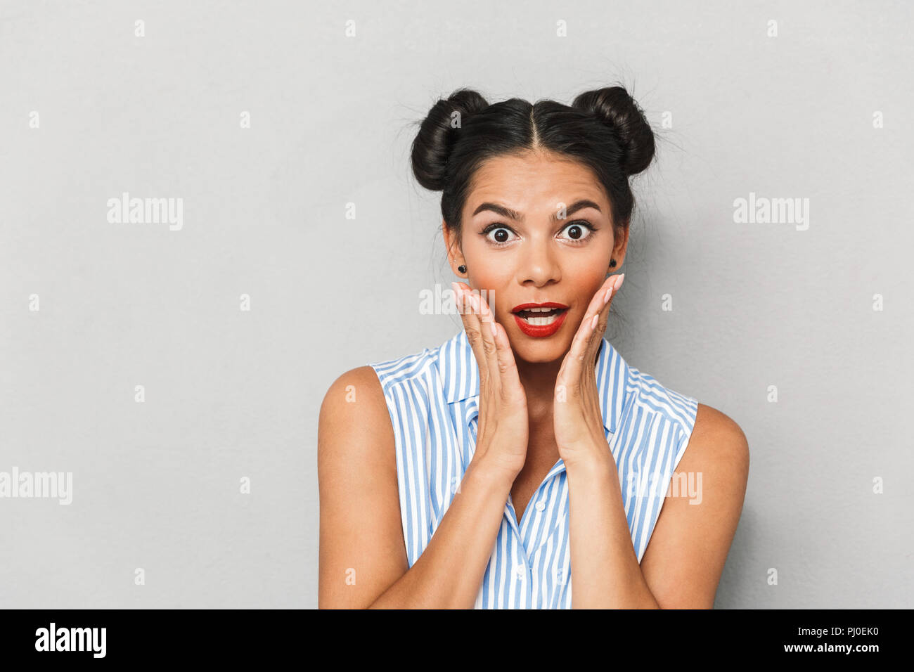 Portrait of a shocked young woman isolated, looking at camera Stock ...