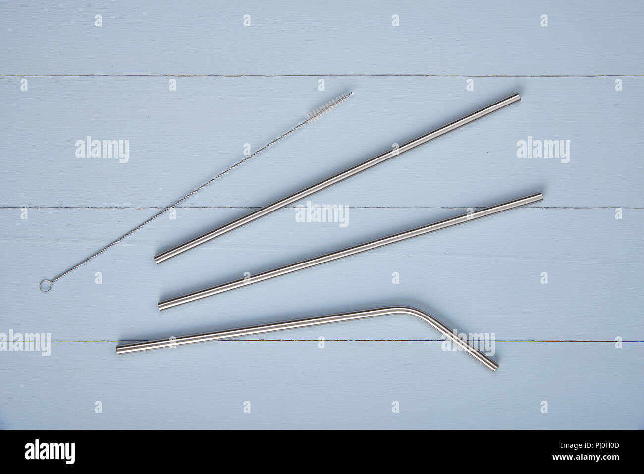 reusable straight and bent stainless steel straws o n a table Stock ...