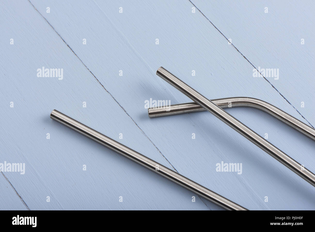Straight stainless steel bent metal straw with a blue silicone straw ...