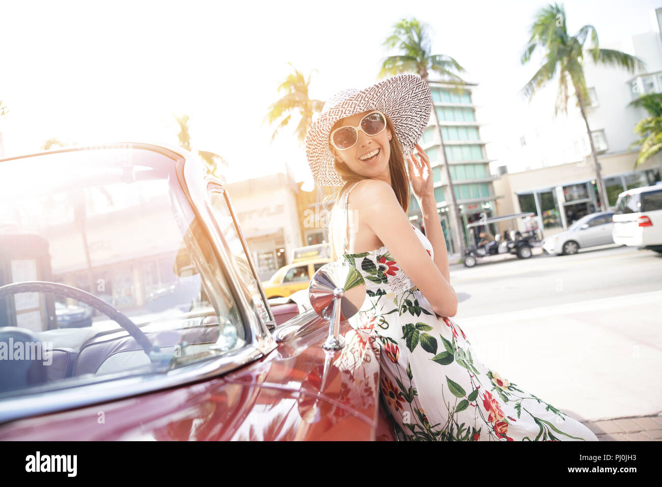 Model posing by old-fashioned car Stock Photo - Alamy