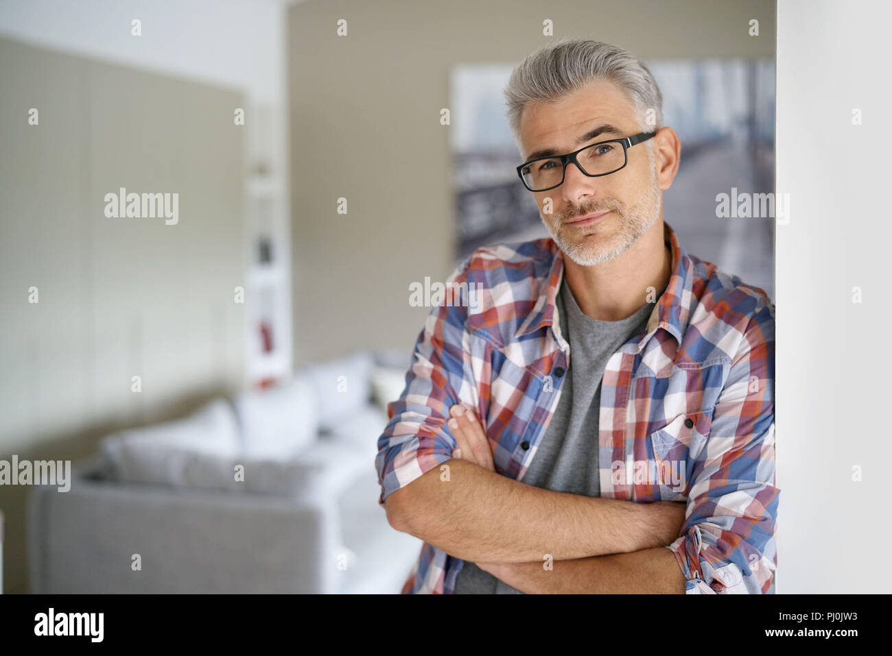 Smiling 40-year-old man standing at home Stock Photo - Alamy
