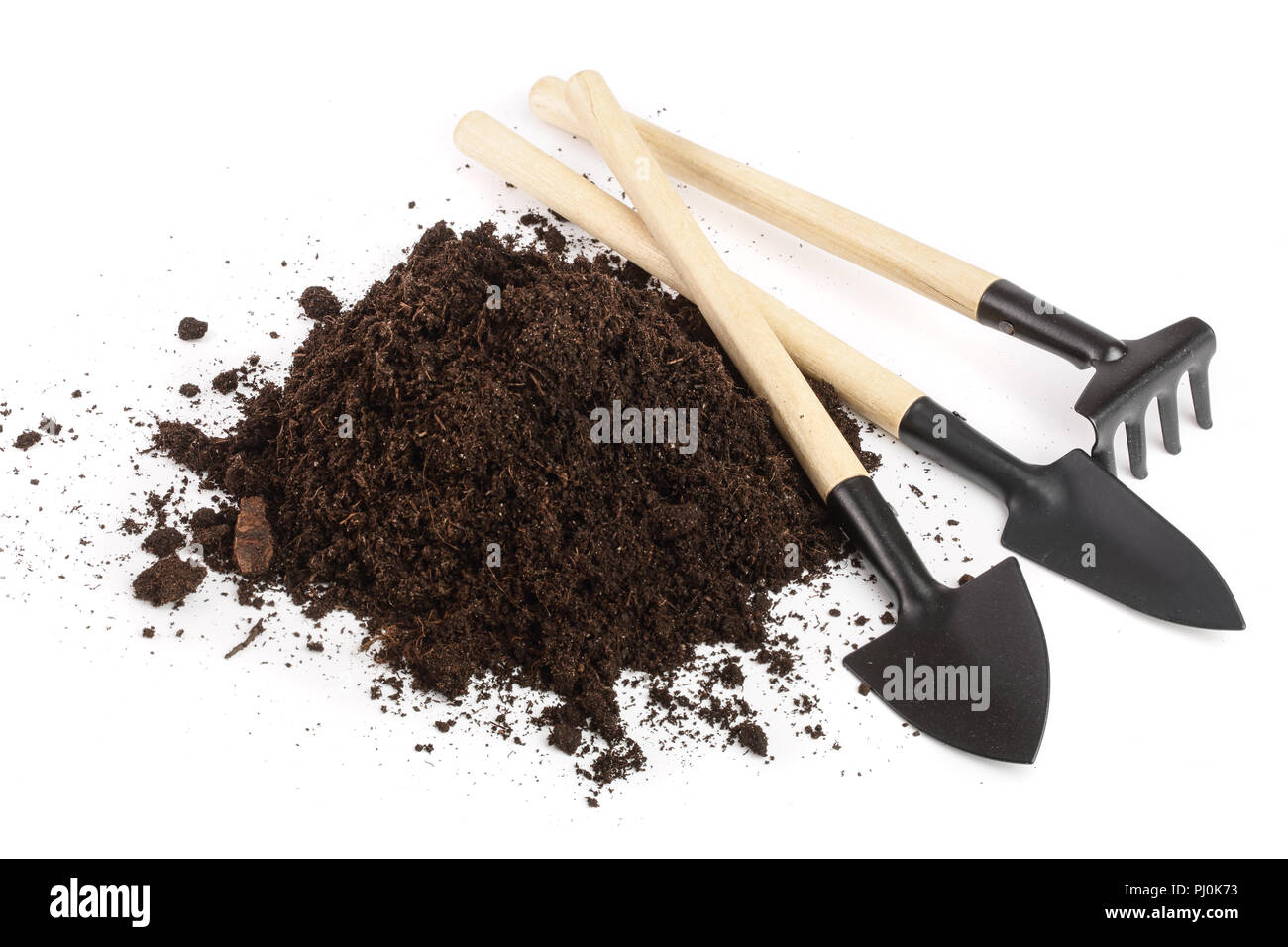 garden tools in soil isolated on white background Stock Photo - Alamy