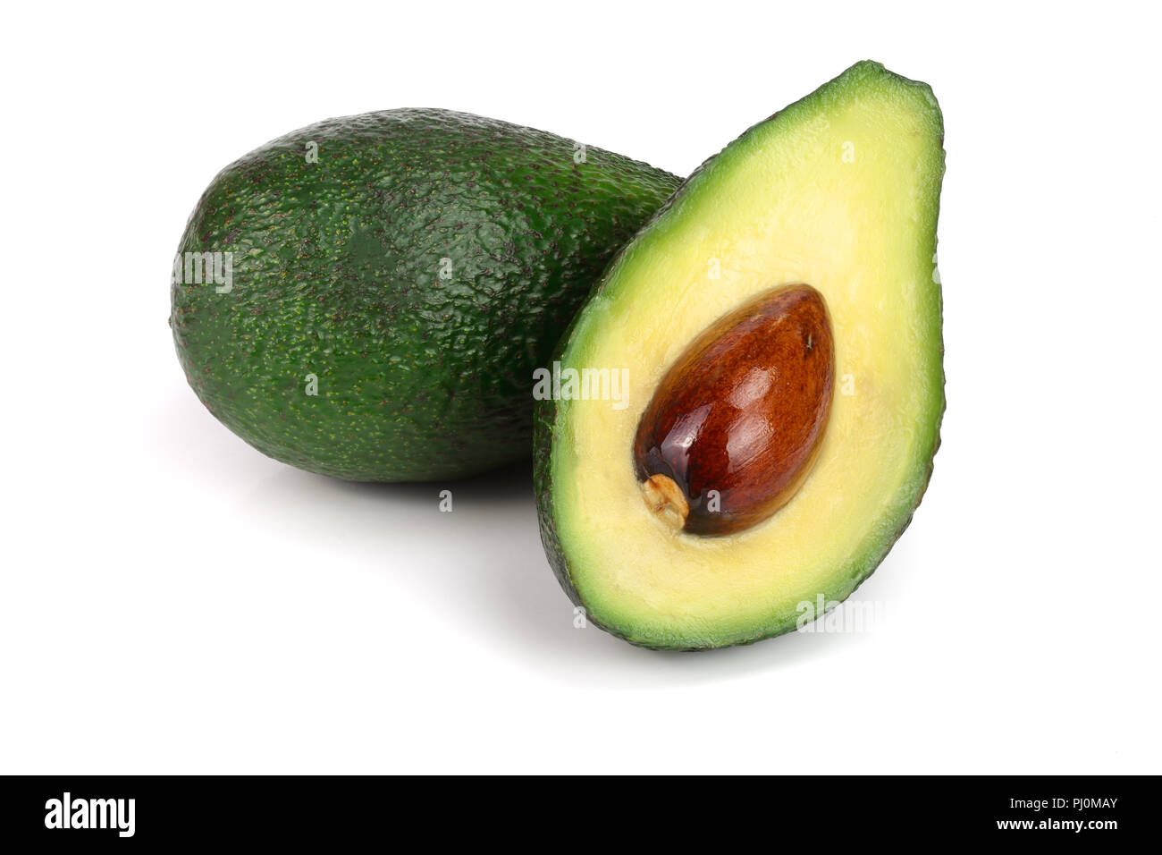 whole and half avocado isolated on white background close-up. Top view ...