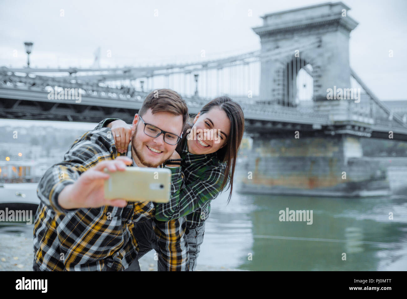 young couple hug old chain bridge on background. budapest, hungary ...