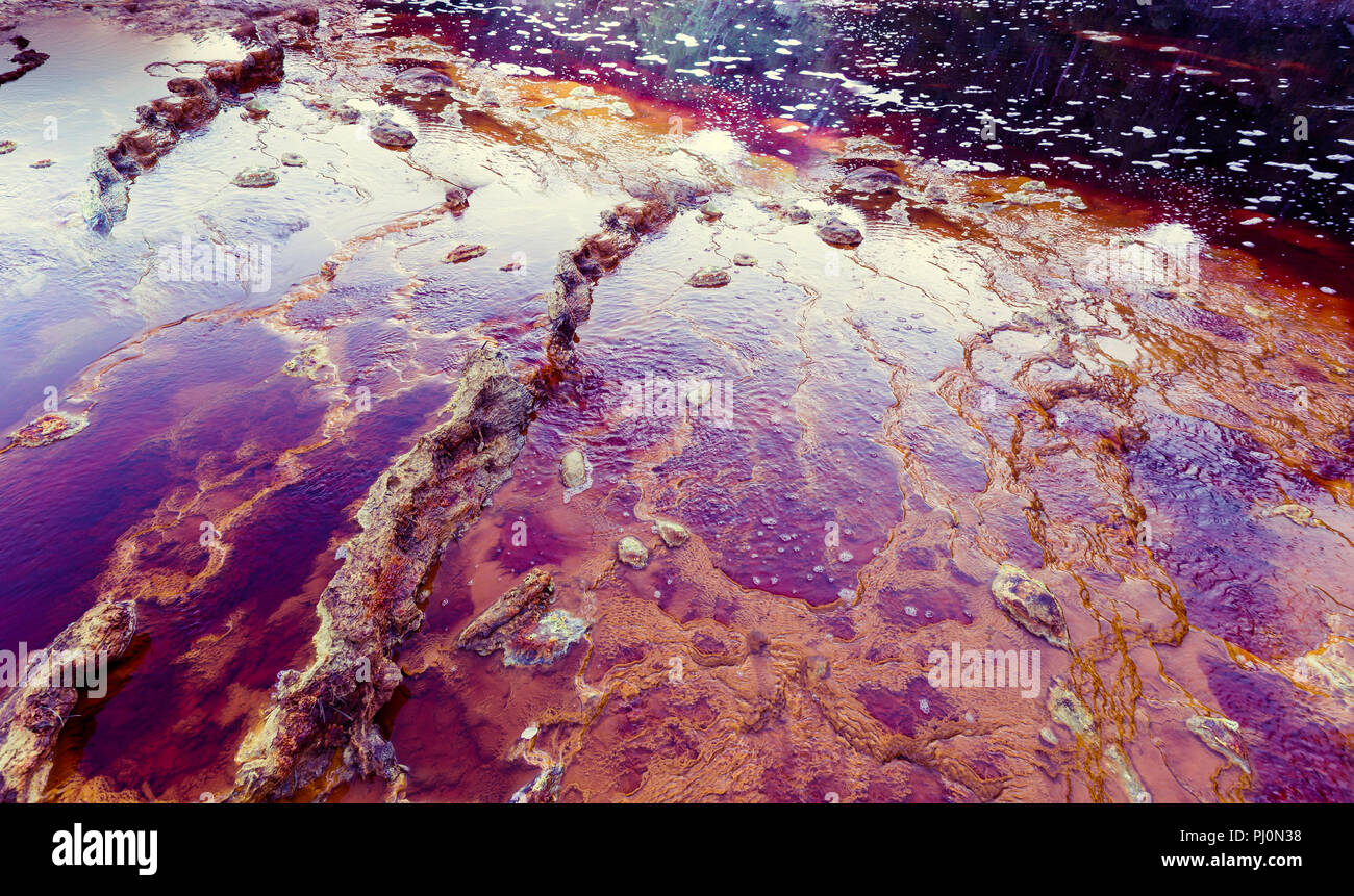 River with red waters with rocks and stromatolites, this environment is ...