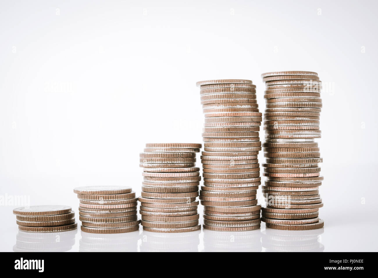 saving money coin stack on white background Stock Photo - Alamy