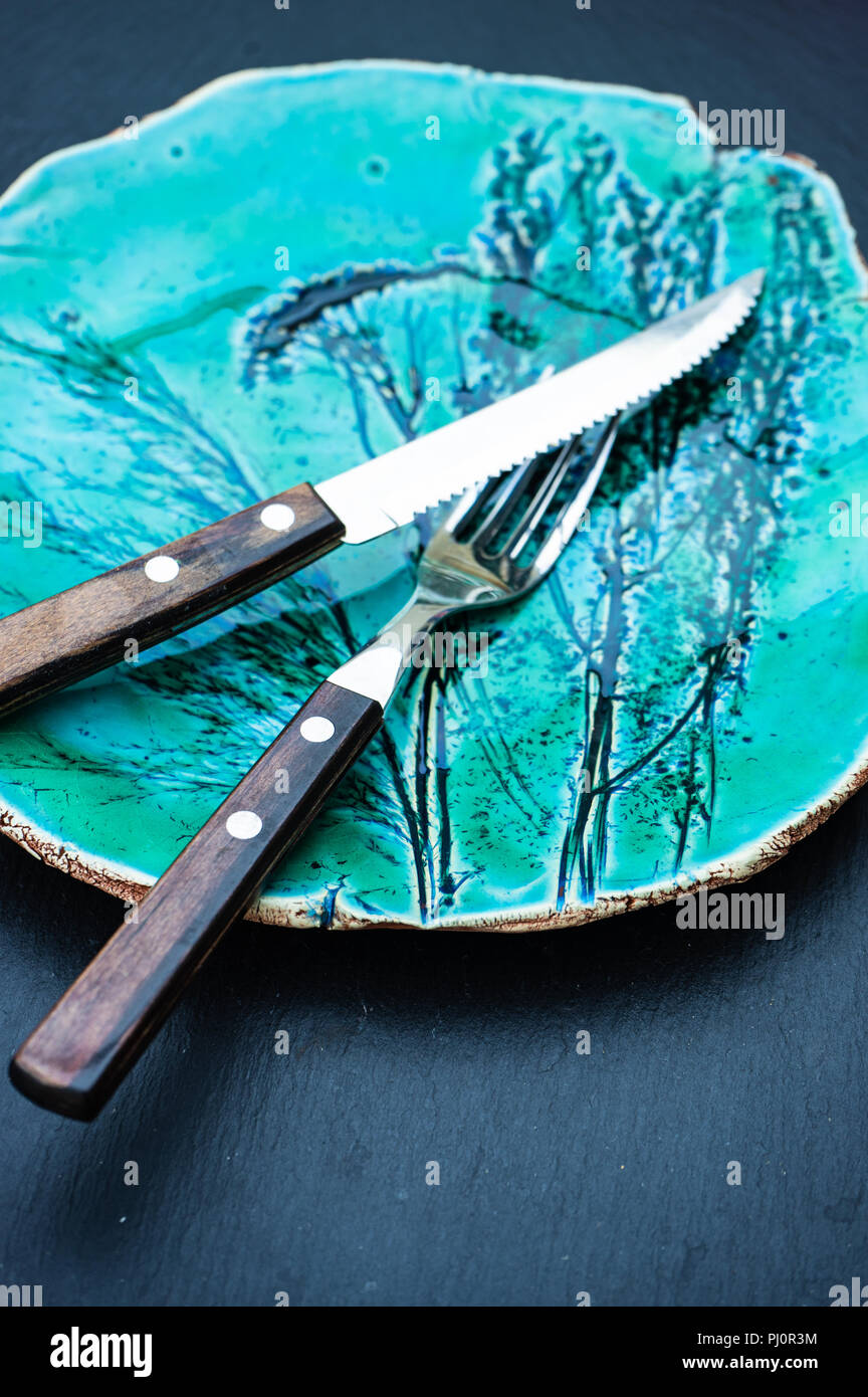 Rustic table setting with ceramic plate and vintage silverware Stock ...