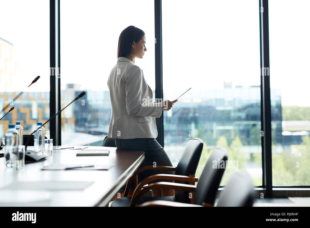 Successful businesswoman in conference room hi-res stock photography ...