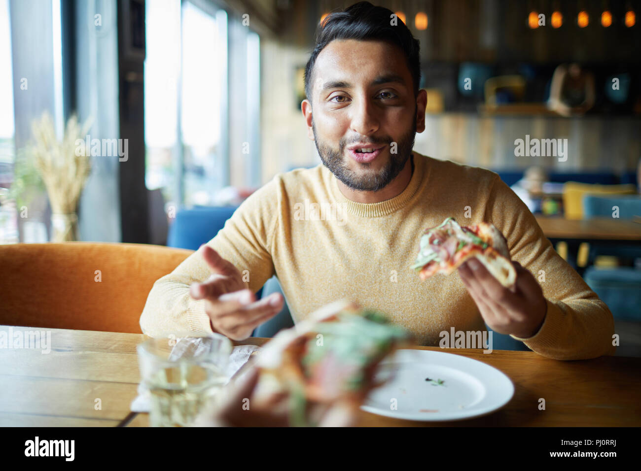 Talking while eating Stock Photo - Alamy
