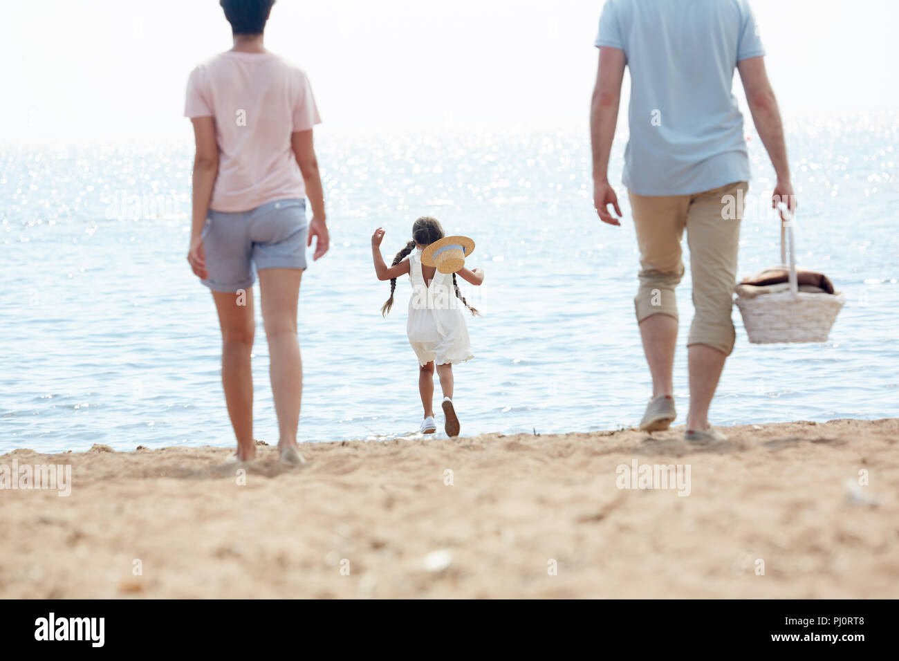 Family Arriving to Beach Stock Photo - Alamy