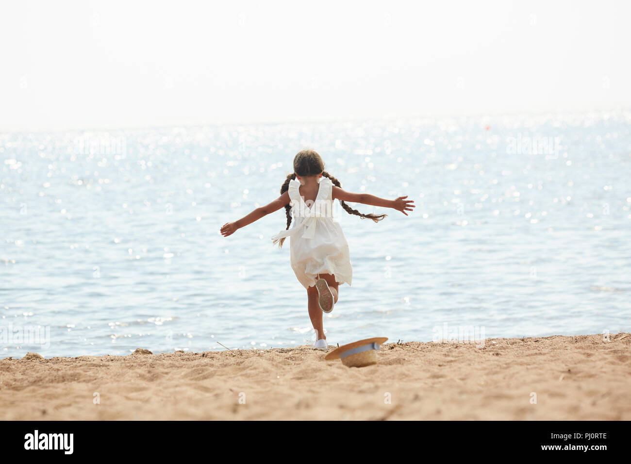 Happy Little Girl Running to Sea Stock Photo - Alamy