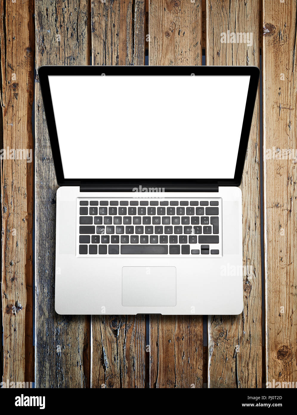 Modern laptop device from above on wooden table. Clipping path for ...